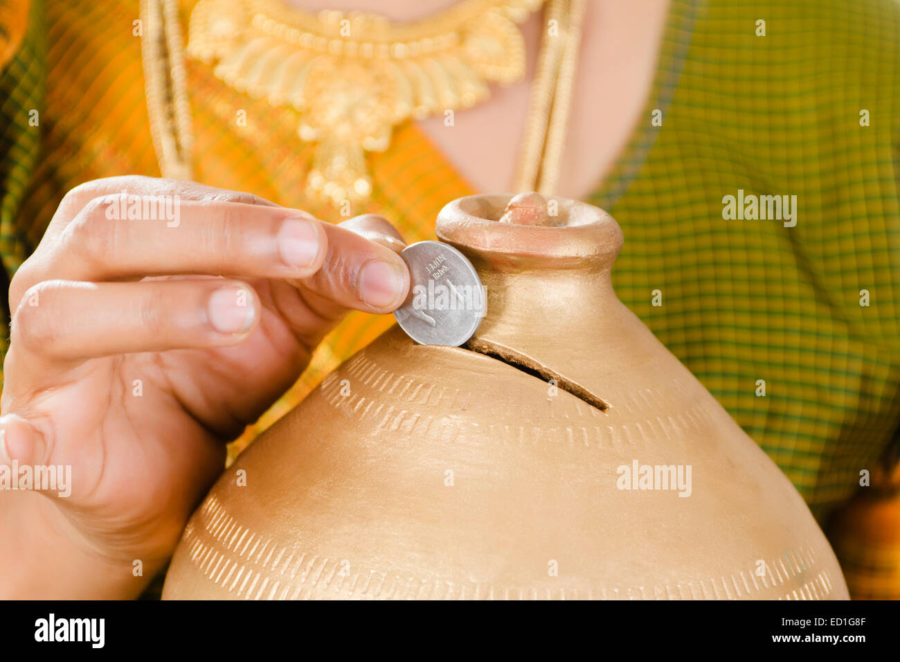 1 South indian Lady saving money Piggy Bank Stock Photo - Alamy