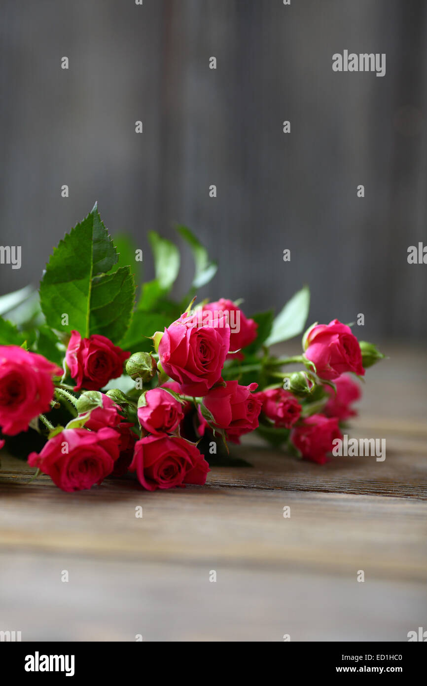 Bouquet of roses on wooden boards, pink flowers Stock Photo - Alamy