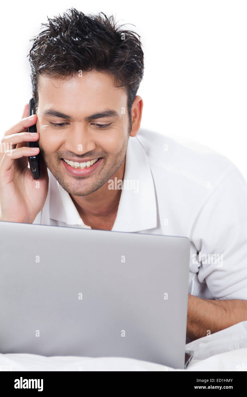 Man on bed with laptop and phone hi-res stock photography and images ...