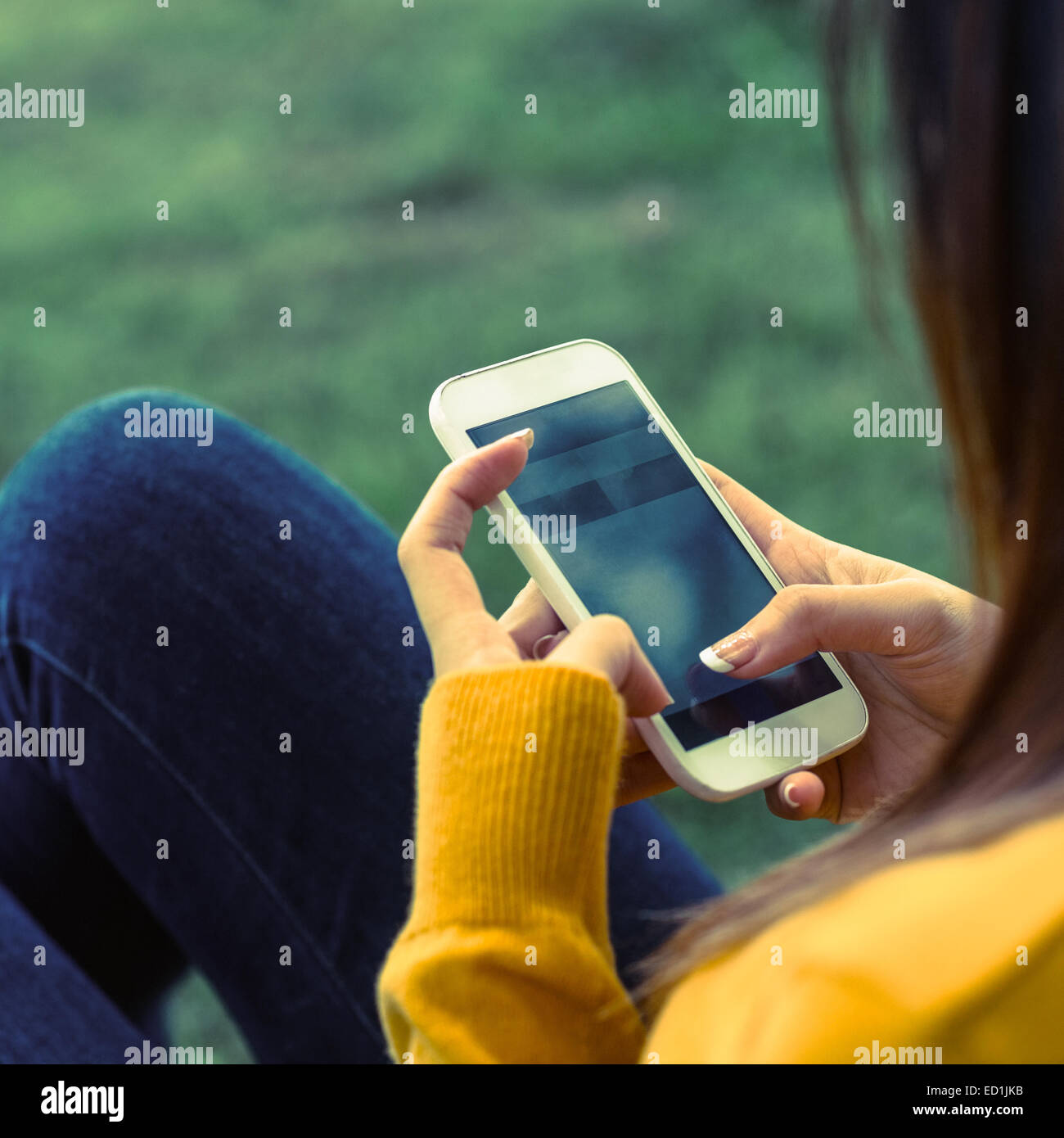 Woman text messaging in park Stock Photo - Alamy