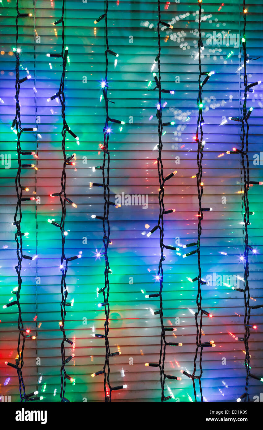 outdoor Christmas festoons decorate window in night Stock Photo - Alamy