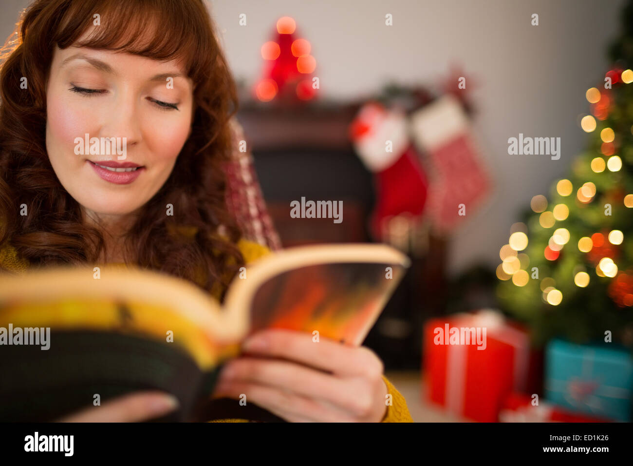 Beauty red hair reading a boo at christmas Stock Photo - Alamy