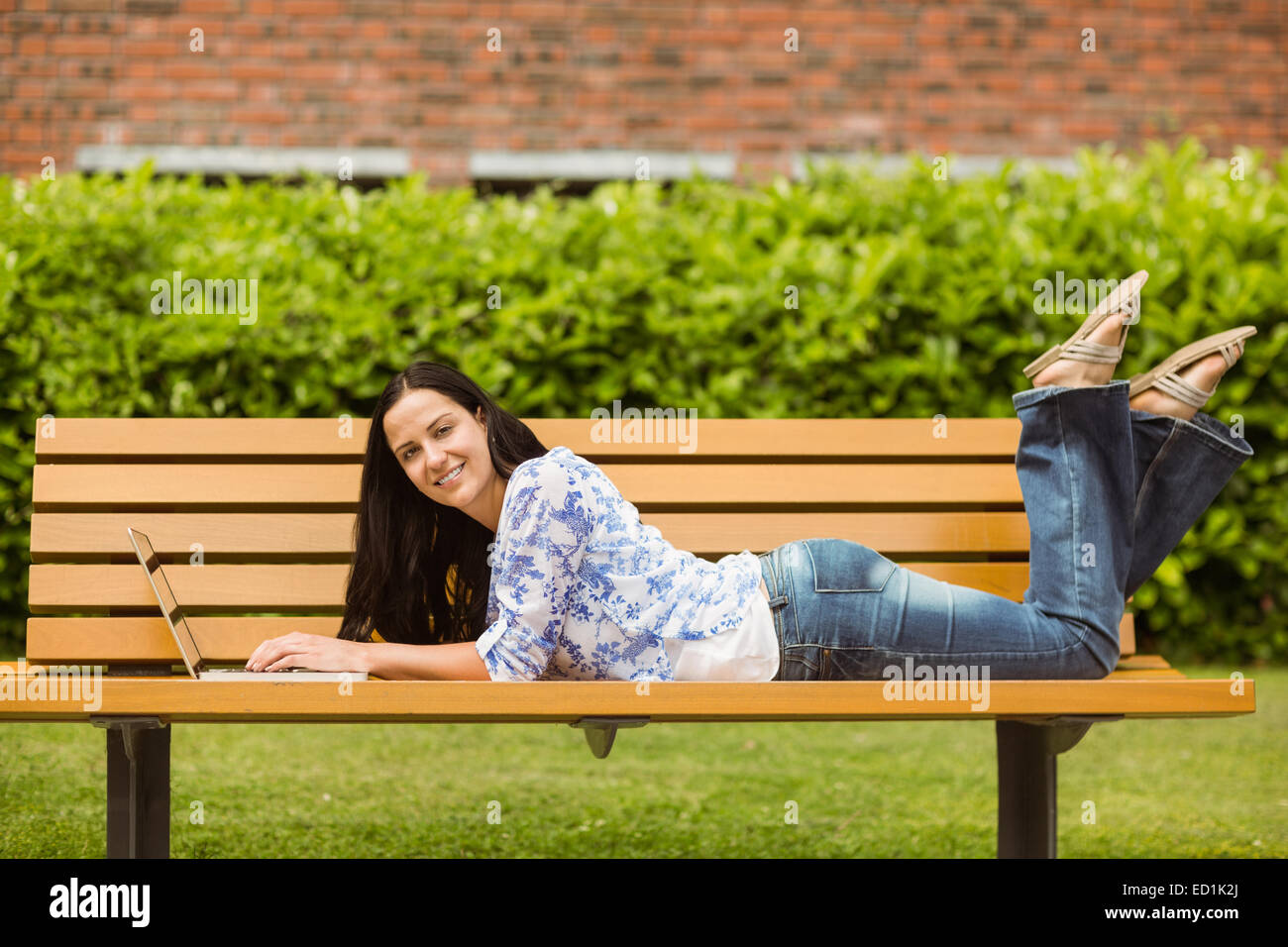 Young woman lying on bench using hi-res stock photography and images ...