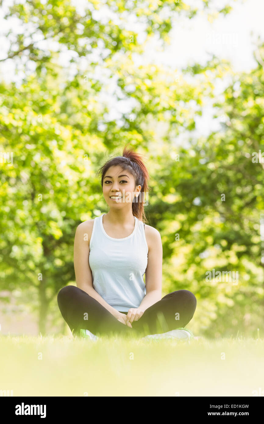 Healthy woman sitting on grass in park Stock Photo - Alamy