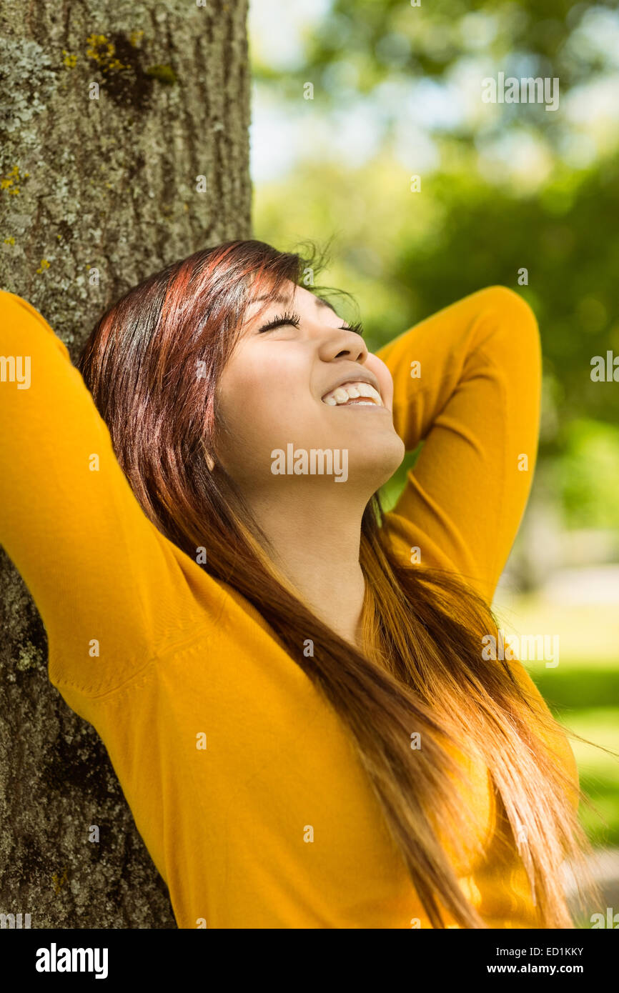 Woman sitting against tree trunk hi-res stock photography and images ...