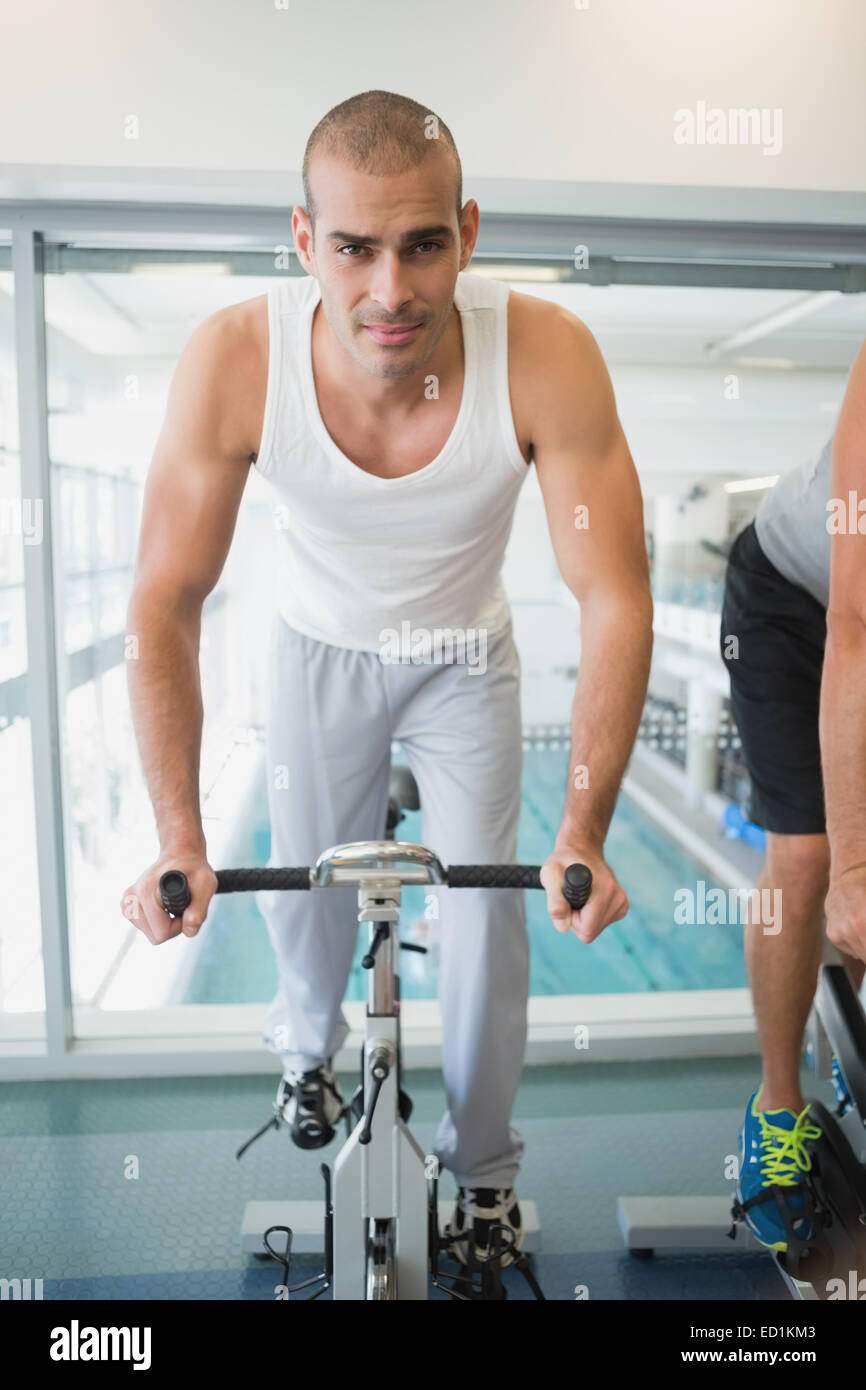 Handsome man working out on exercise bike at gym Stock Photo - Alamy