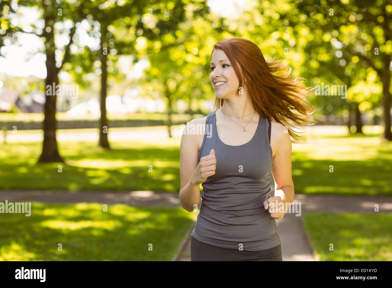 Portrait of a pretty redhead running Stock Photo - Alamy