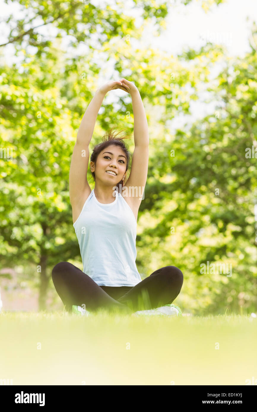 Healthy woman stretching hands in park Stock Photo - Alamy