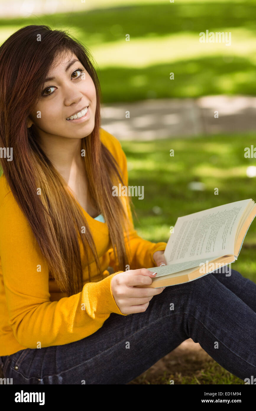 Female student reading in park hi-res stock photography and images - Alamy