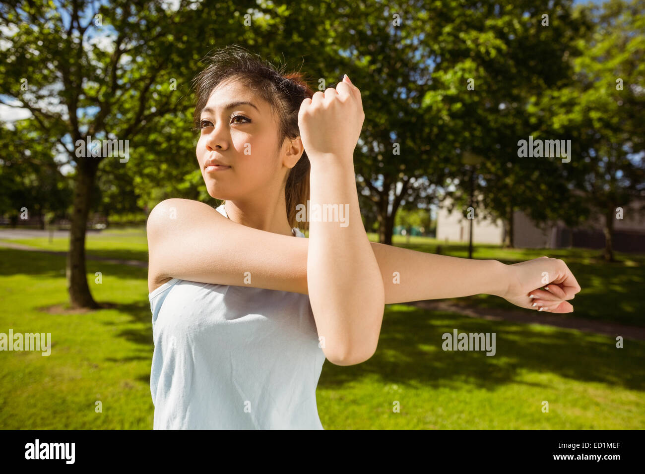 Healthy woman stretching hands in park Stock Photo - Alamy