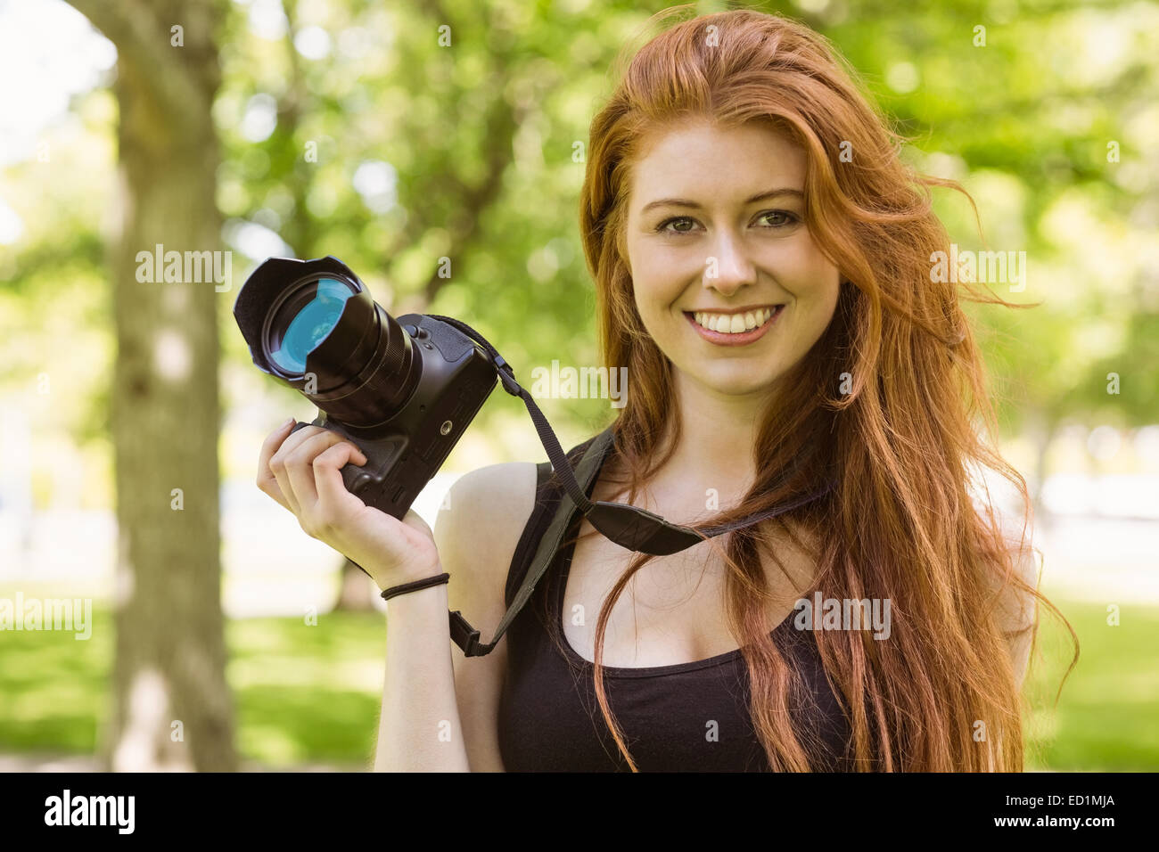 Beautiful female photographer at park Stock Photo - Alamy
