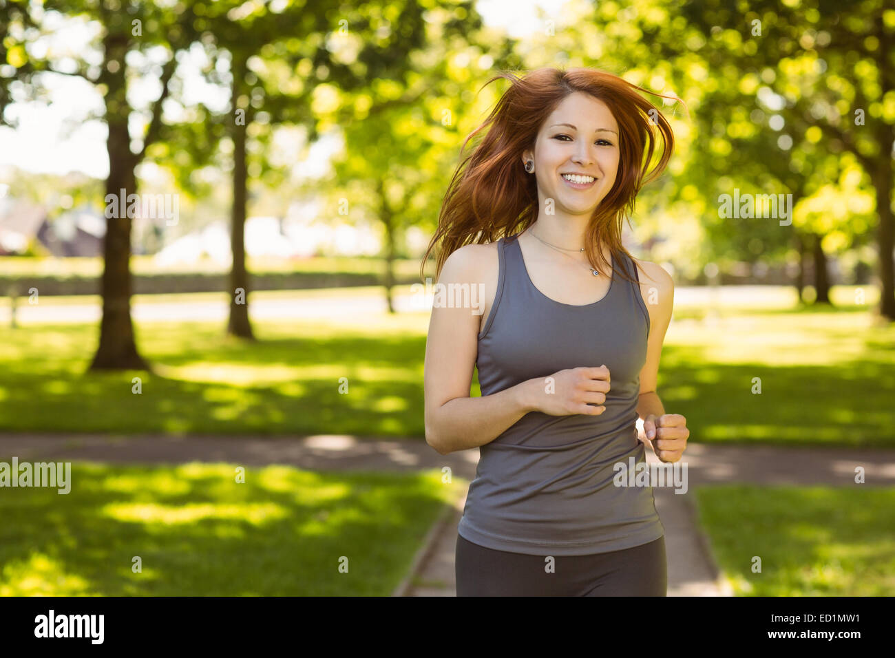 Portrait of a pretty redhead running Stock Photo - Alamy