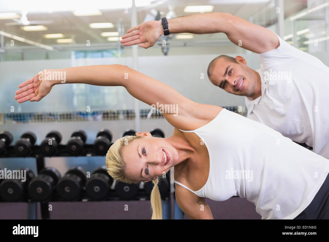 Happy couple stretching hands in yoga class Stock Photo - Alamy
