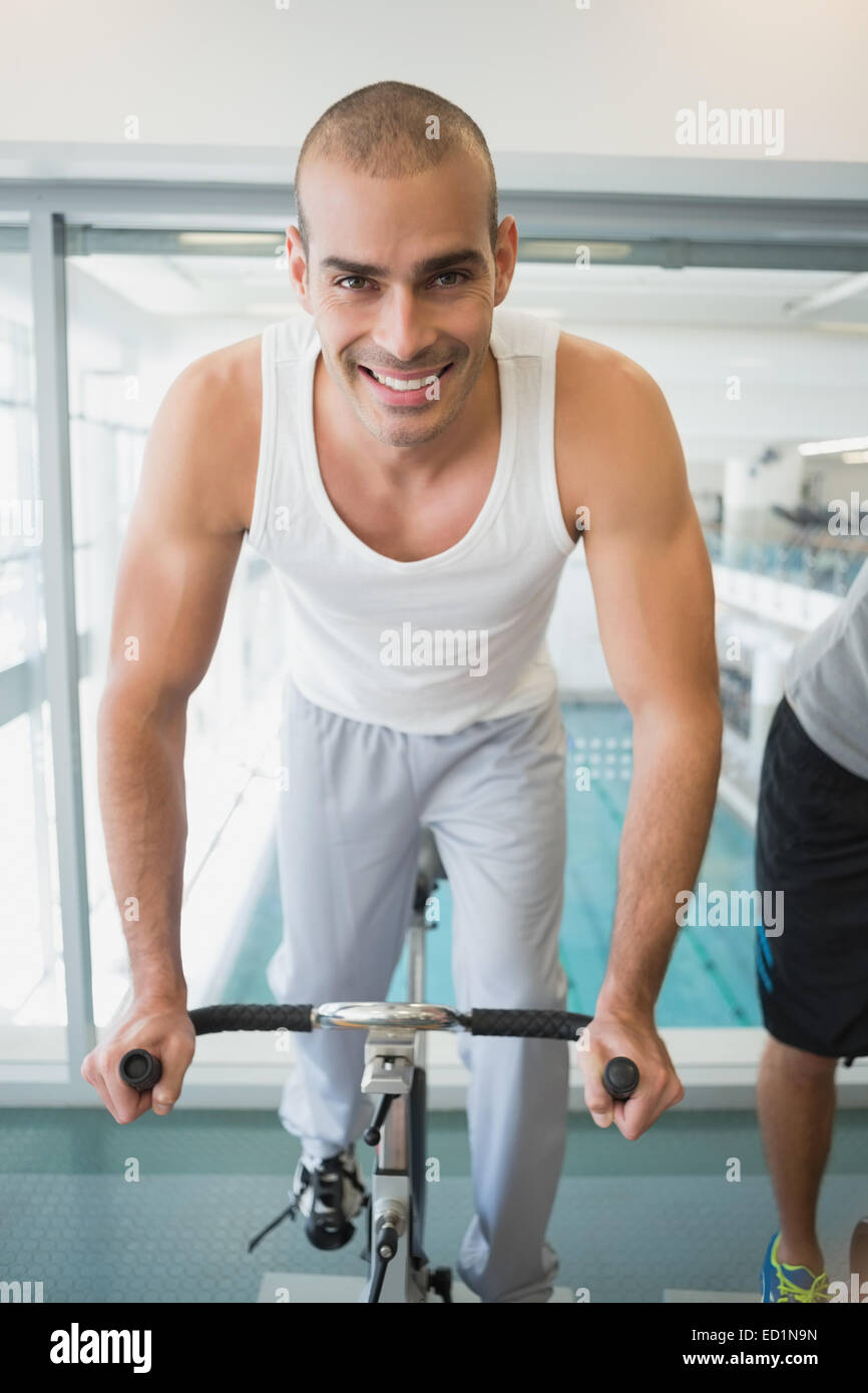 Man working out on exercise bike at gym Stock Photo - Alamy
