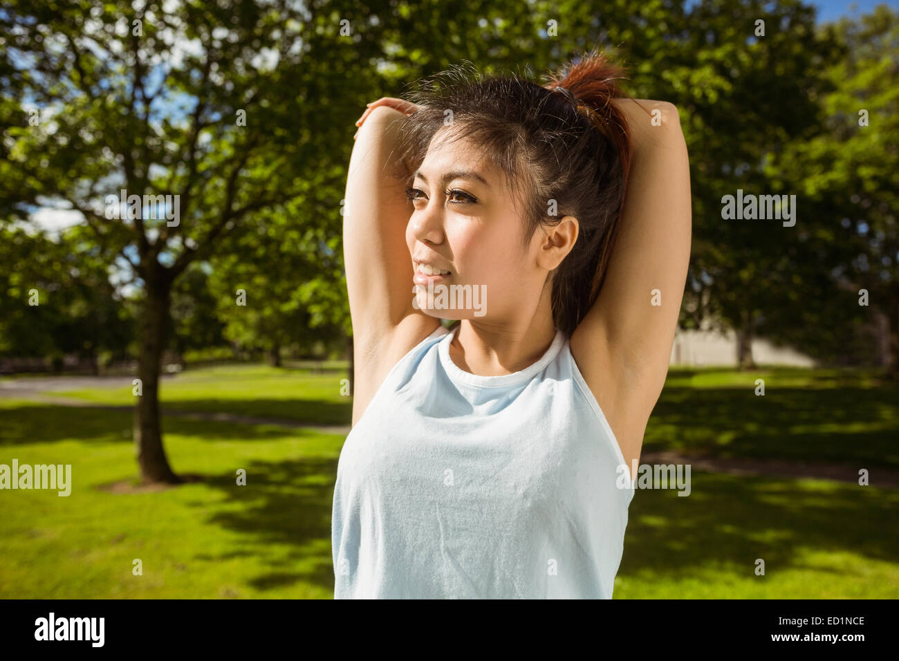 Healthy woman stretching hands in park Stock Photo - Alamy