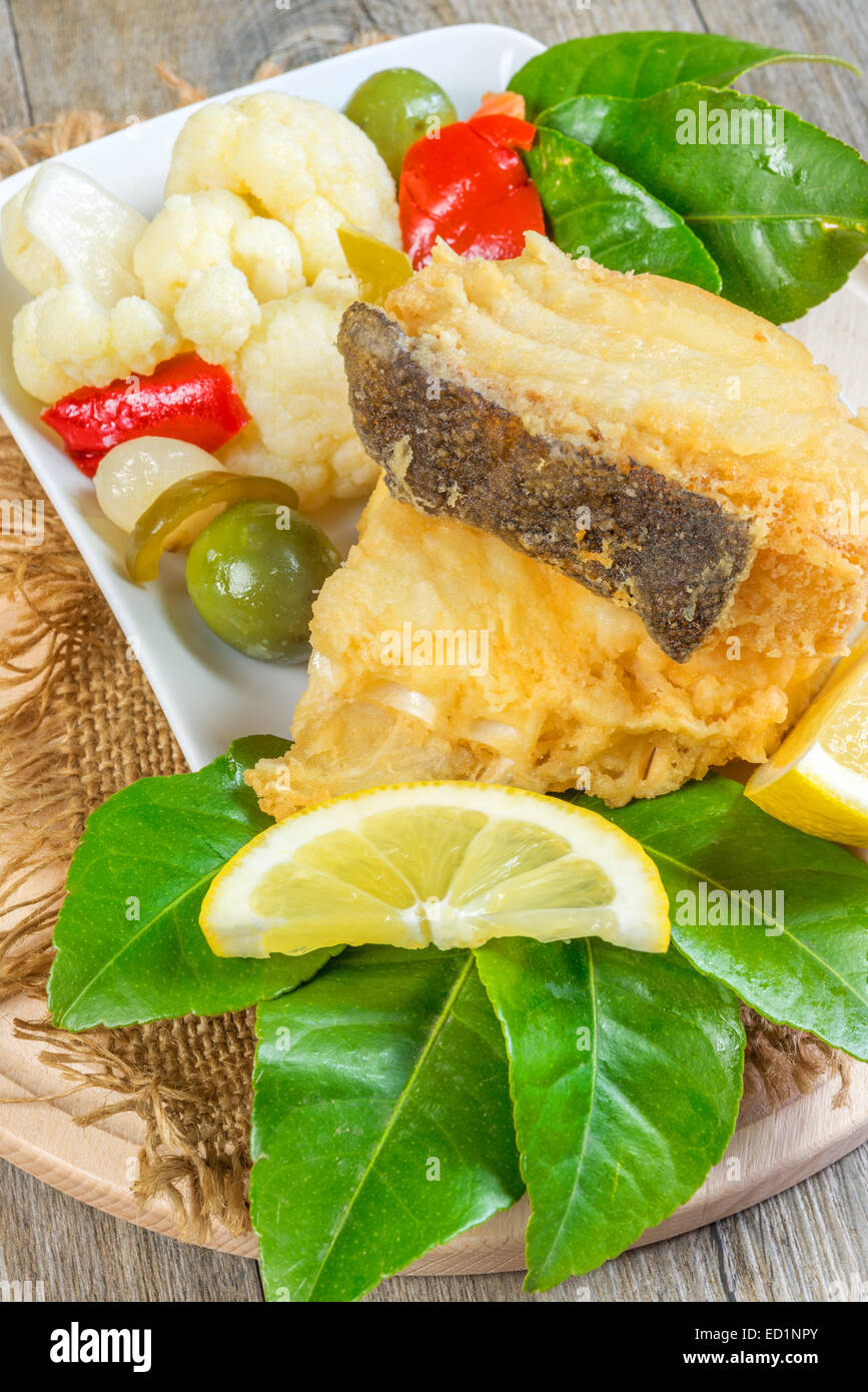 Piece of cod fried on cabbage salad Stock Photo - Alamy