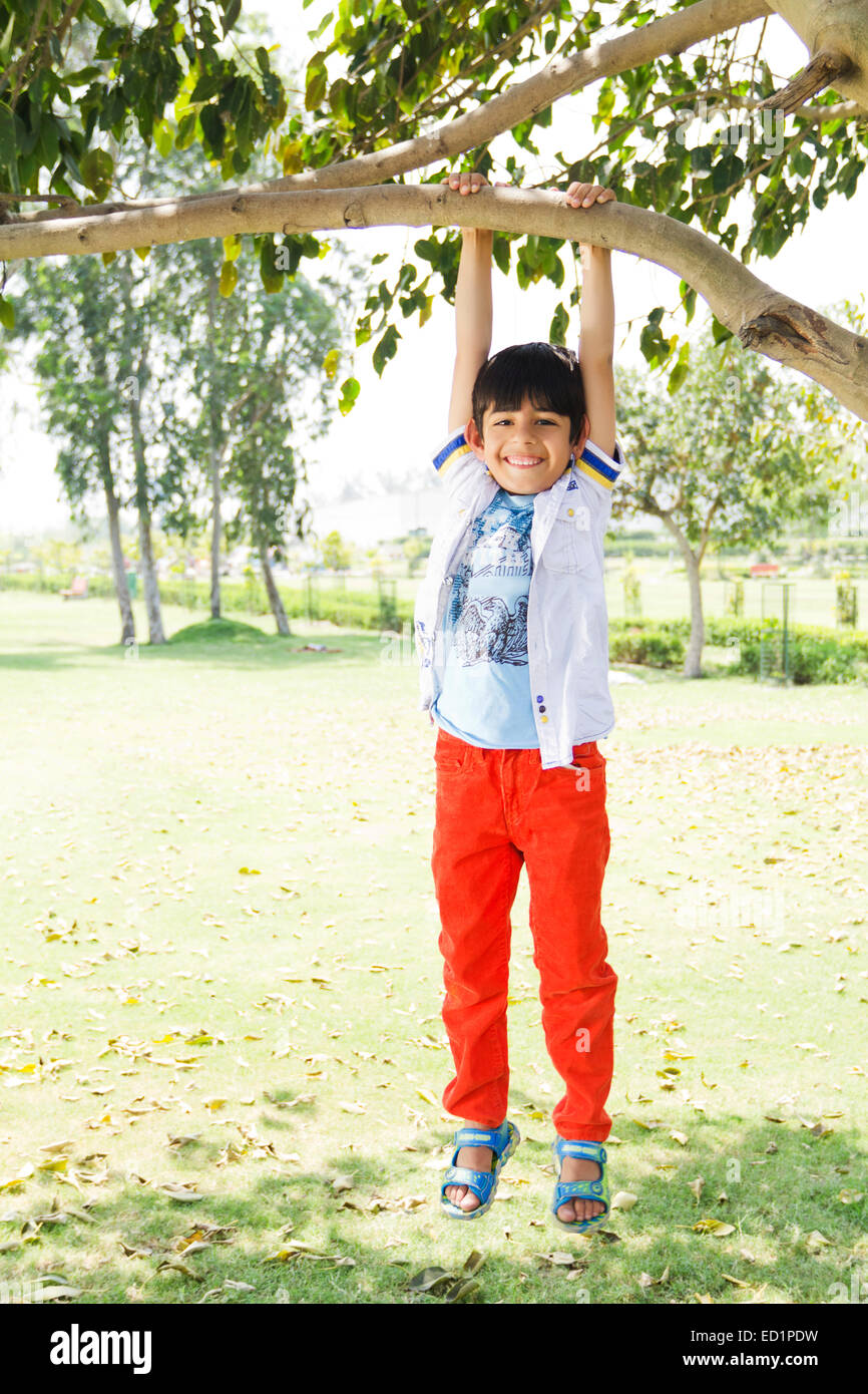 1 indians Child boy park Hanging Tree Trunk Stock Photo - Alamy