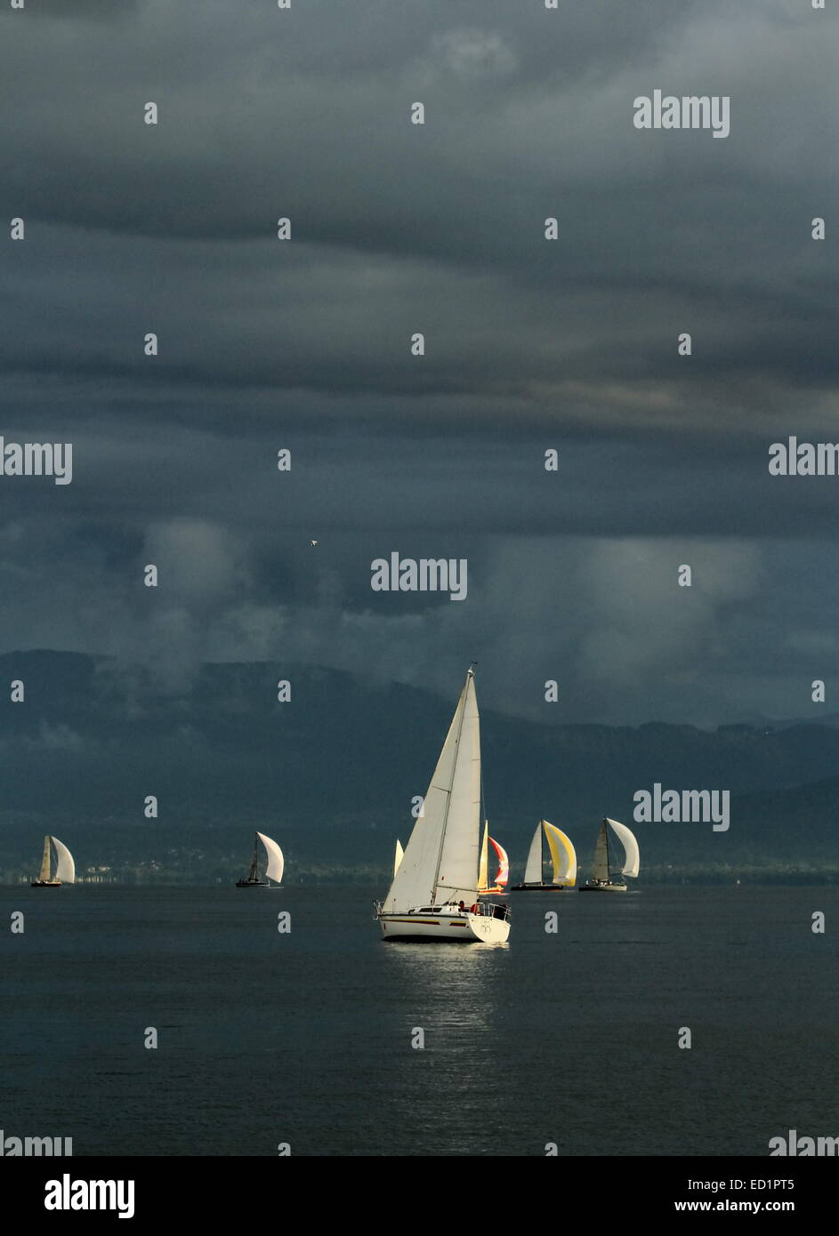 Colorful sailboat sailing on a calm evening with dramatic sunset ...