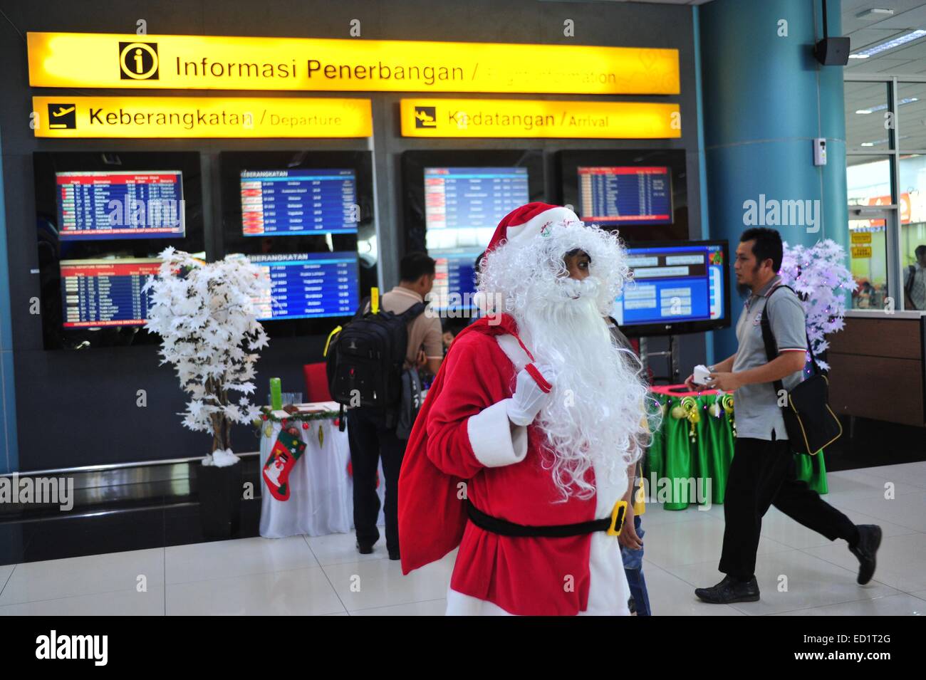 Jakarta, Indonesia. 24th Dec, 2014. A Santa Claus stands in front of a ...