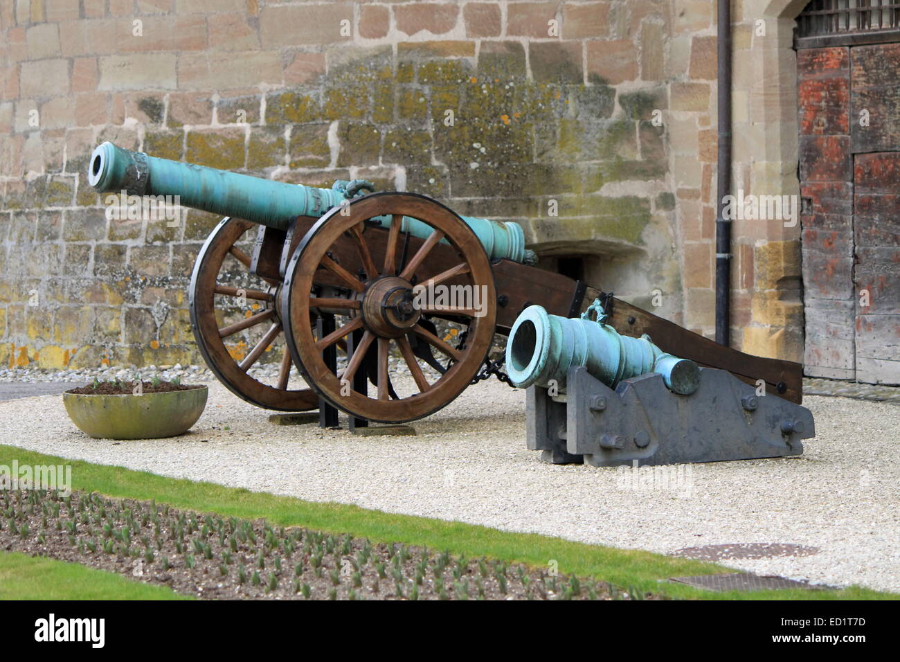Two medieval canons standing at the entrance of middle ages castle ...