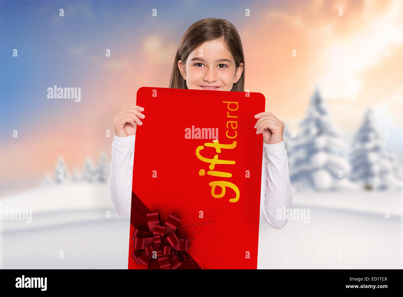 Composite image of cute little girl showing card Stock Photo - Alamy