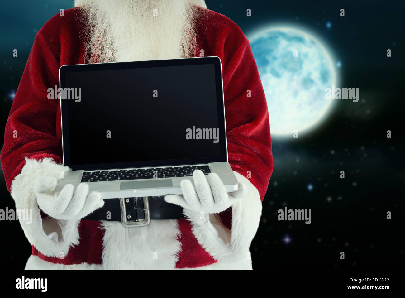 Composite image of santa claus presents a laptop Stock Photo - Alamy