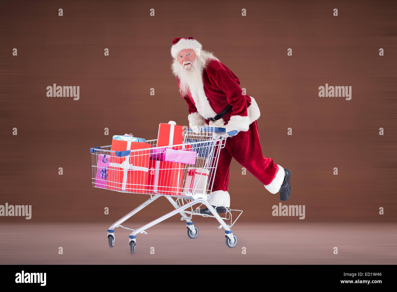 Composite image of santa pushing shopping cart Stock Photo - Alamy