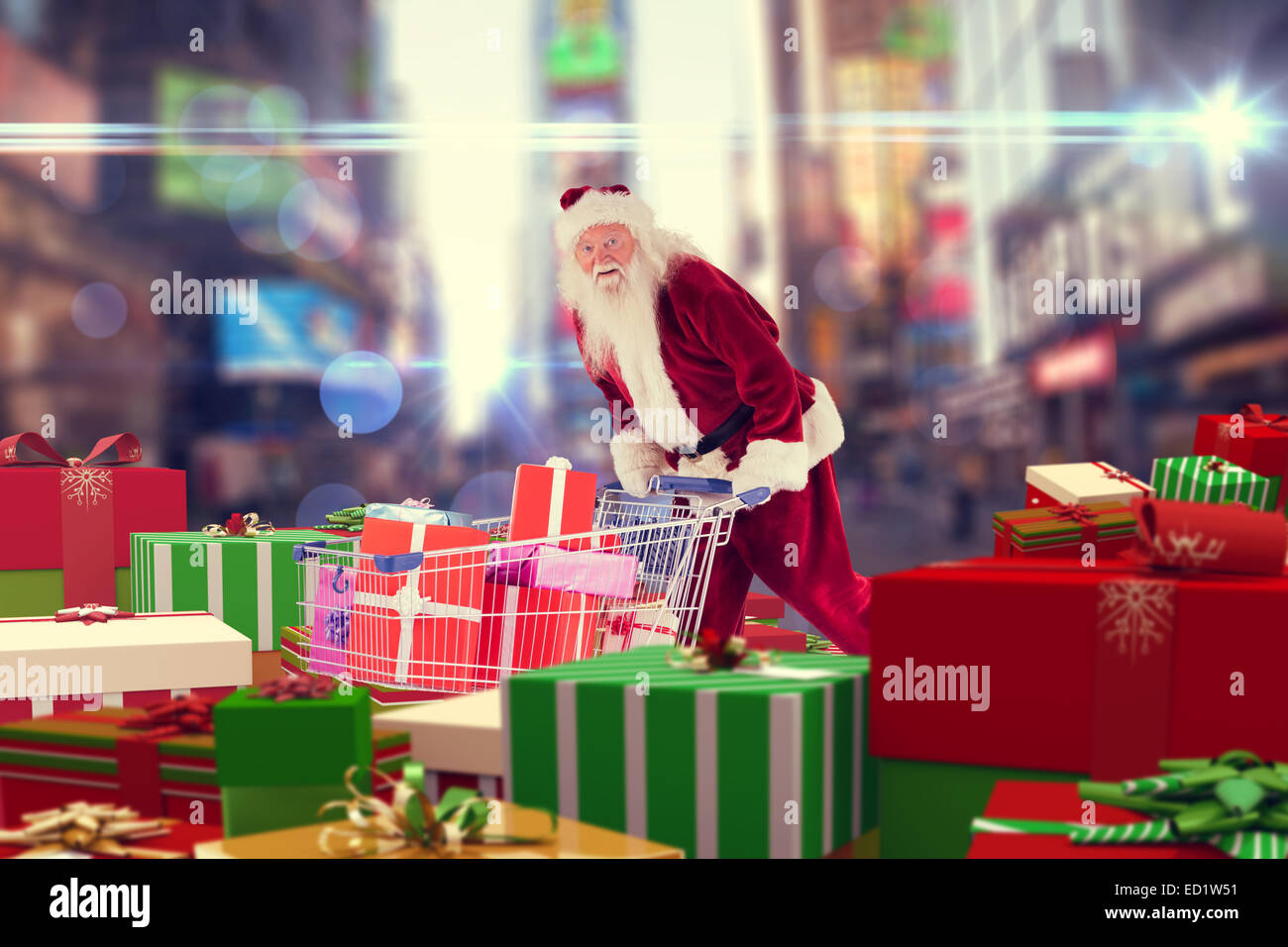 Composite image of santa delivering gifts from cart Stock Photo - Alamy