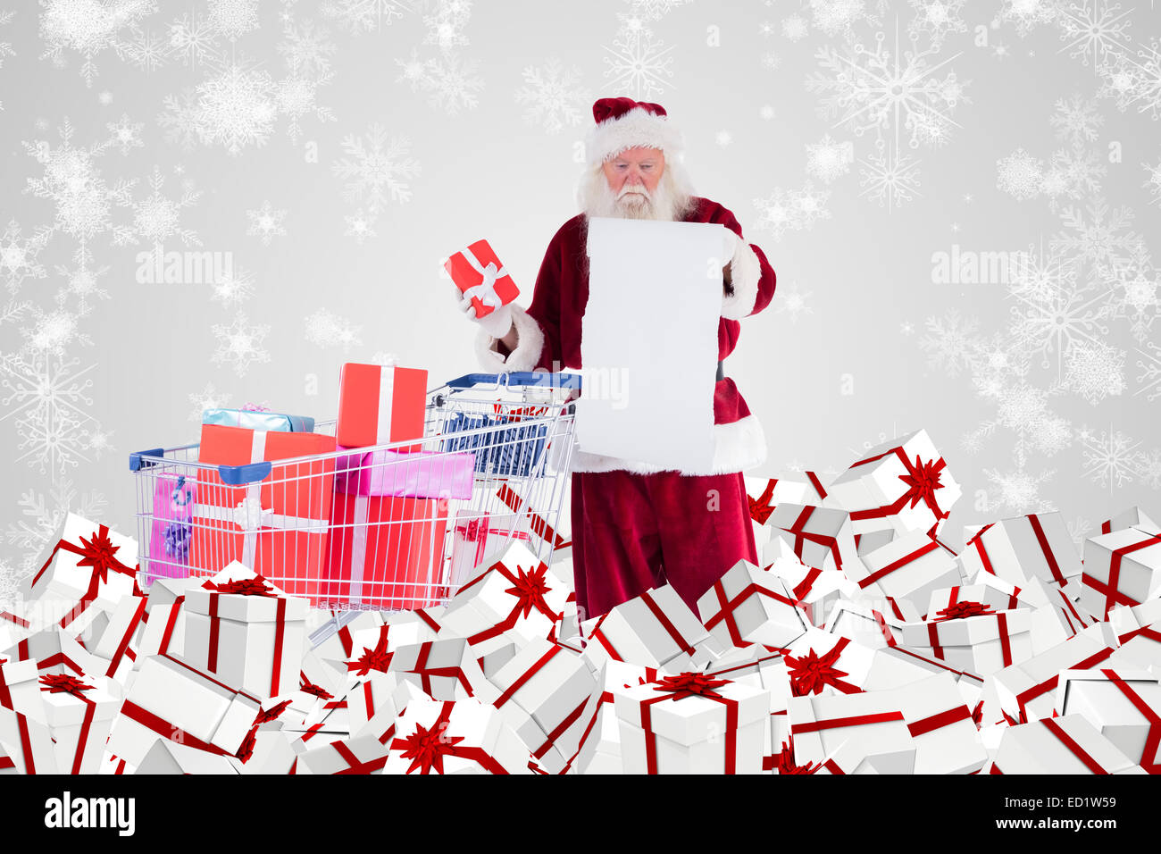 Composite image of santa delivering gifts from cart Stock Photo - Alamy