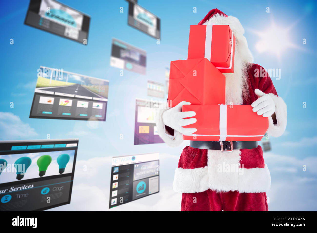 Composite image of santa covers his face with presents Stock Photo - Alamy