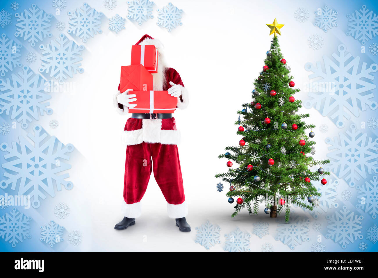 Composite image of santa covers his face with presents Stock Photo - Alamy