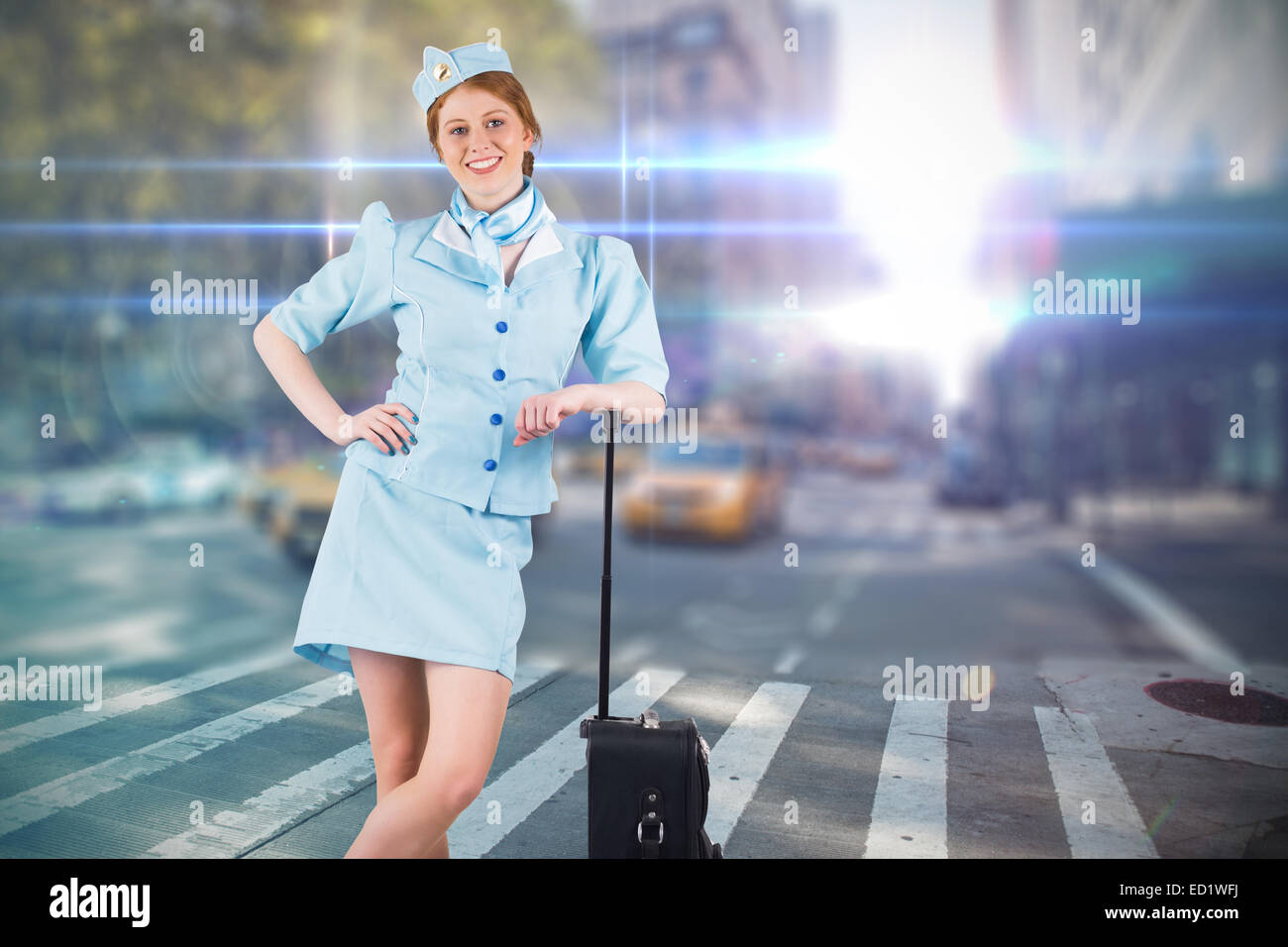 Composite image of pretty air hostess smiling at camera Stock Photo - Alamy
