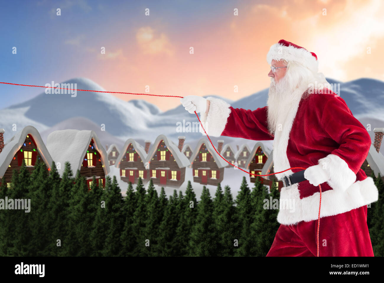 Composite image of santa pulls something with a rope Stock Photo - Alamy