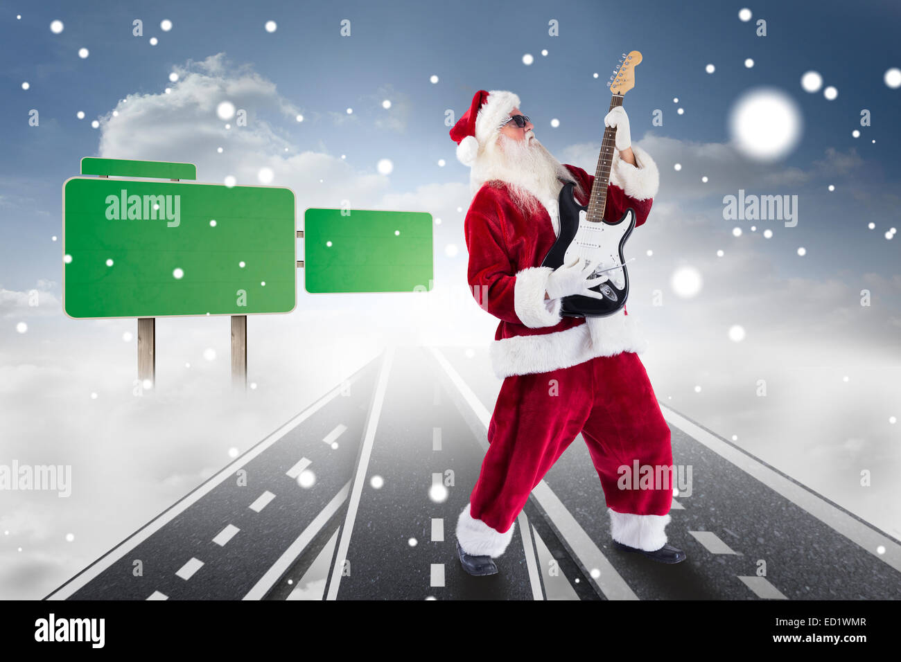 Composite image of santa playing electric guitar Stock Photo - Alamy