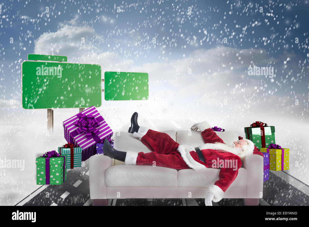 Composite image of santa claus taking a nap Stock Photo - Alamy