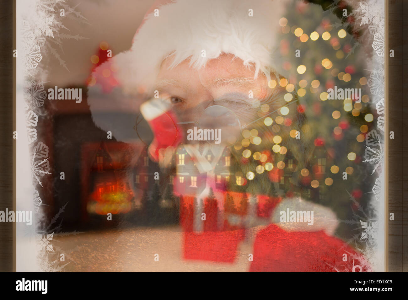 Composite image of santa claus winking Stock Photo - Alamy