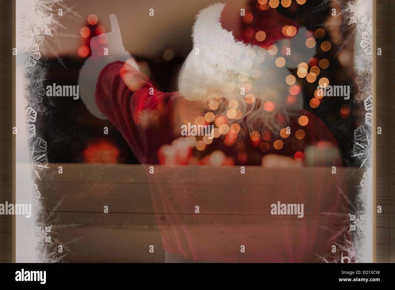 Composite image of santa claus points at something Stock Photo - Alamy