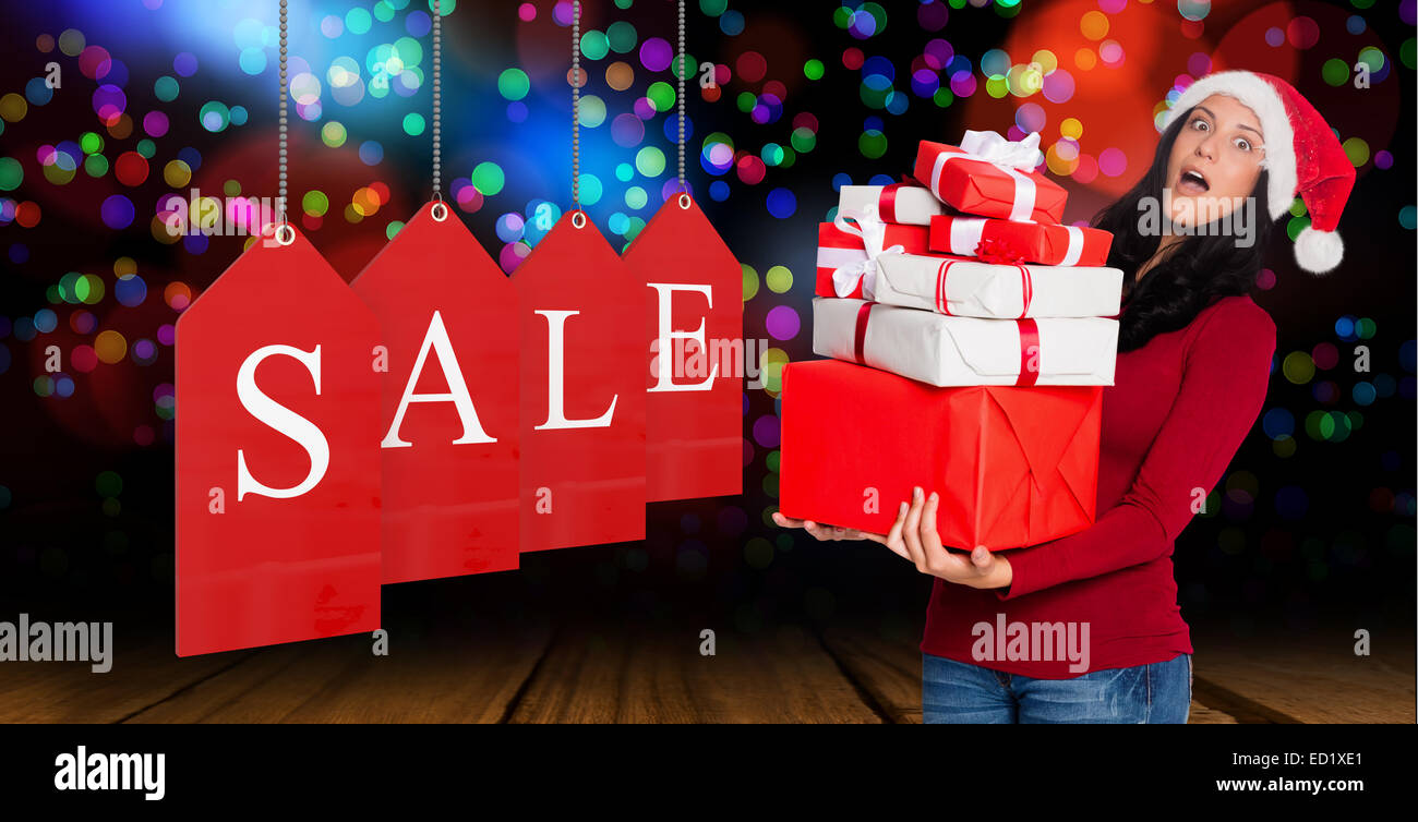 Composite image of woman holding many christmas presents Stock Photo ...