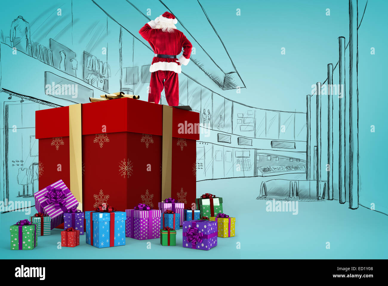 Composite image of santa standing on giant present Stock Photo - Alamy