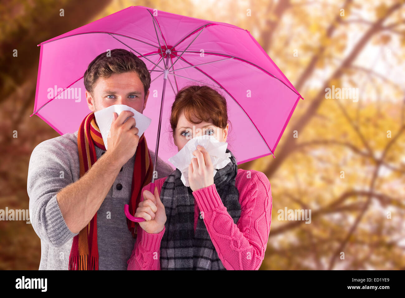 Composite image of couple standing underneath an umbrella Stock Photo ...