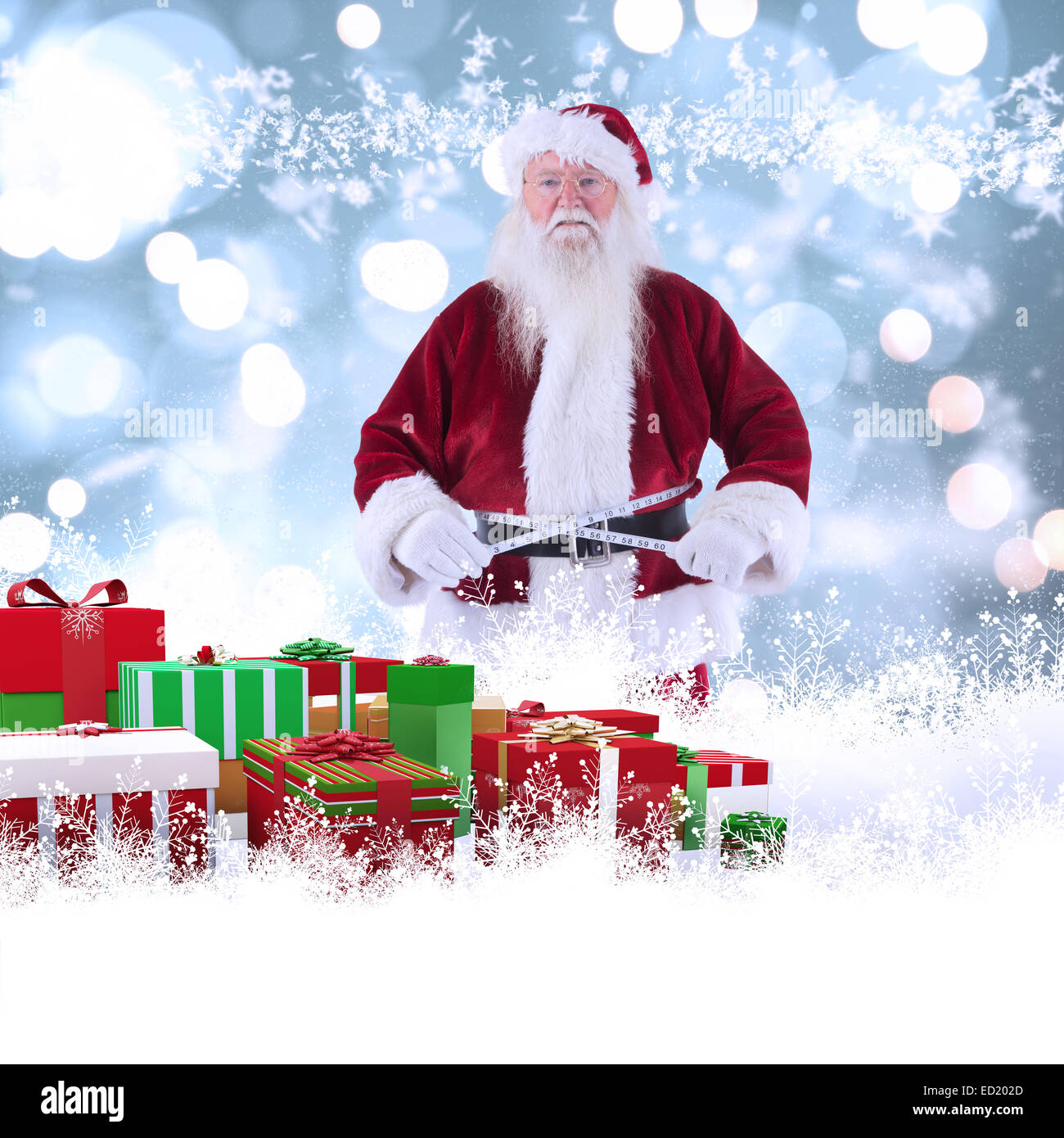 Composite image of santa claus measures his belly Stock Photo - Alamy