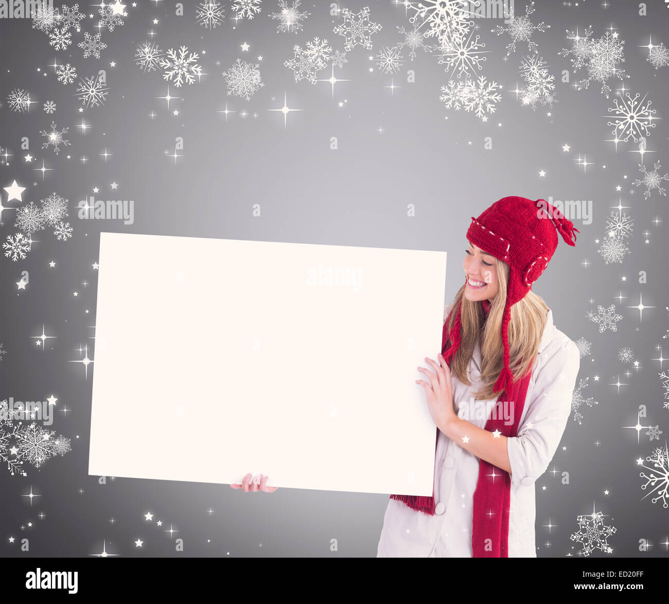 Composite image of pretty blonde showing white poster Stock Photo - Alamy