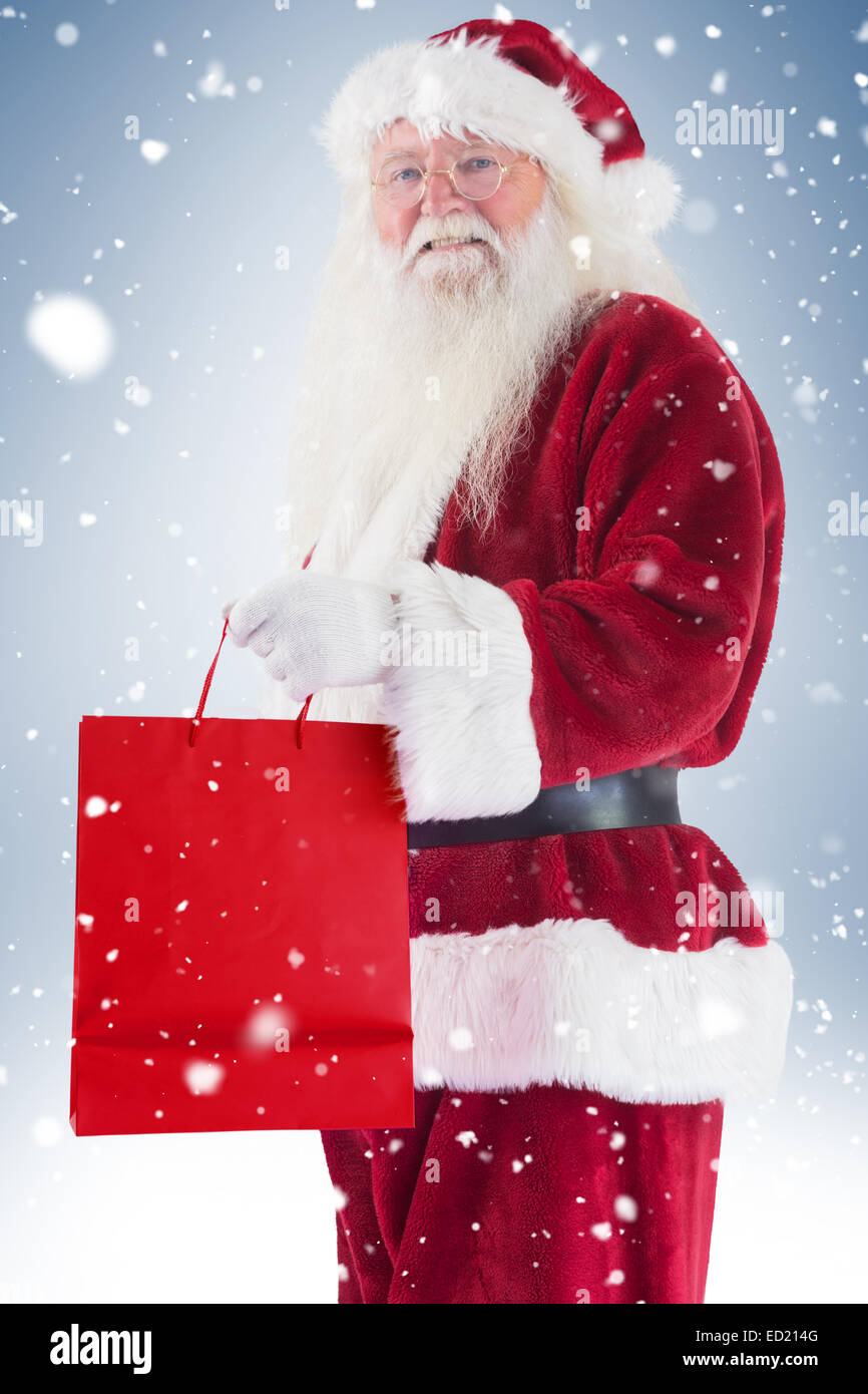 Santa carries red gift bag Stock Photo - Alamy