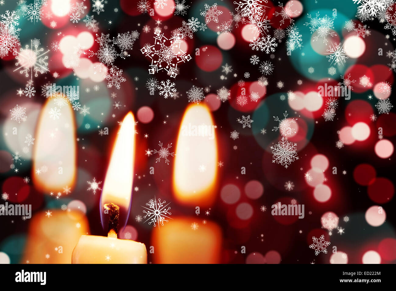 Snowflakes against candle burning Stock Photo - Alamy
