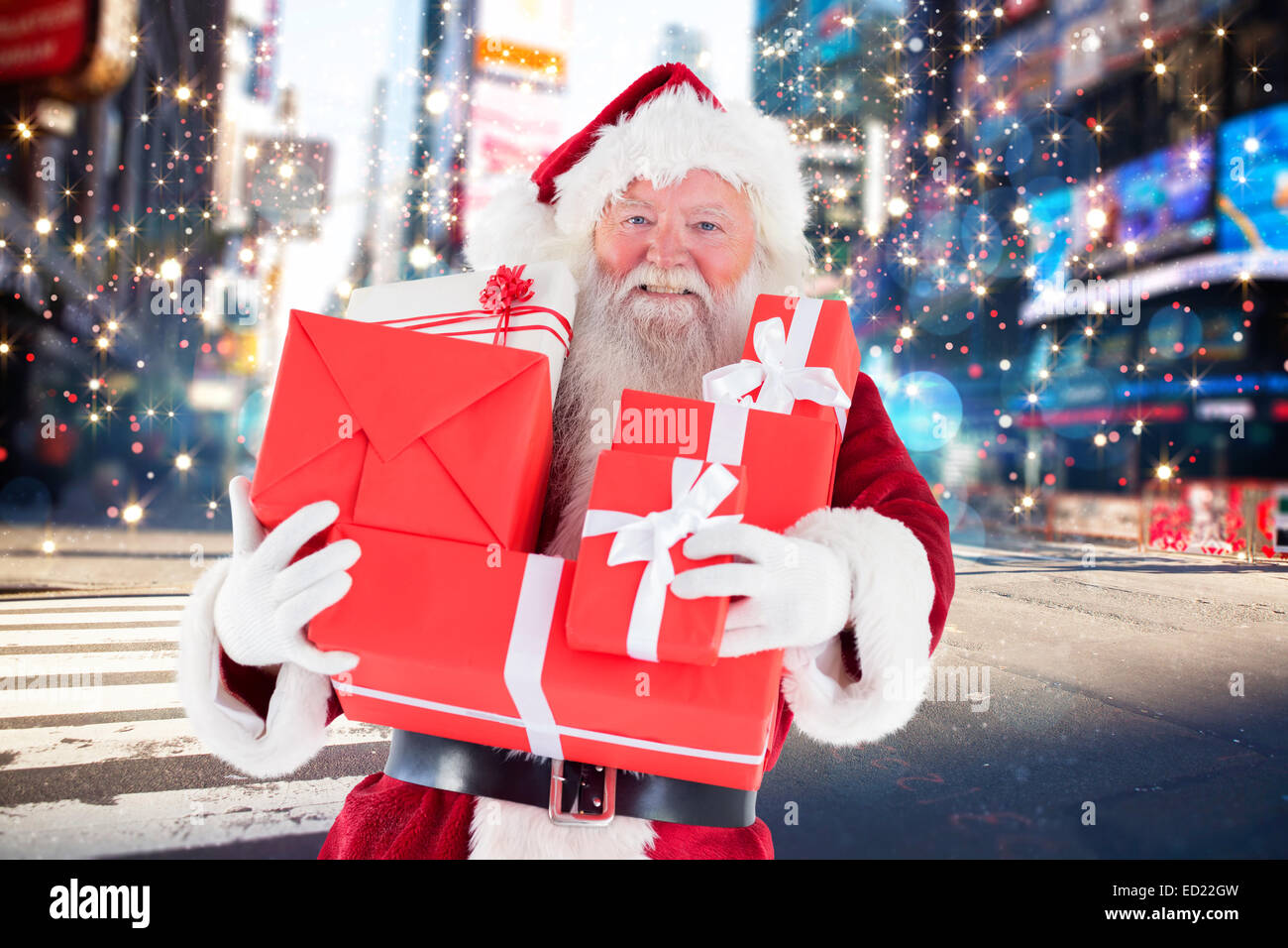 Composite image of santa carries a few presents Stock Photo - Alamy