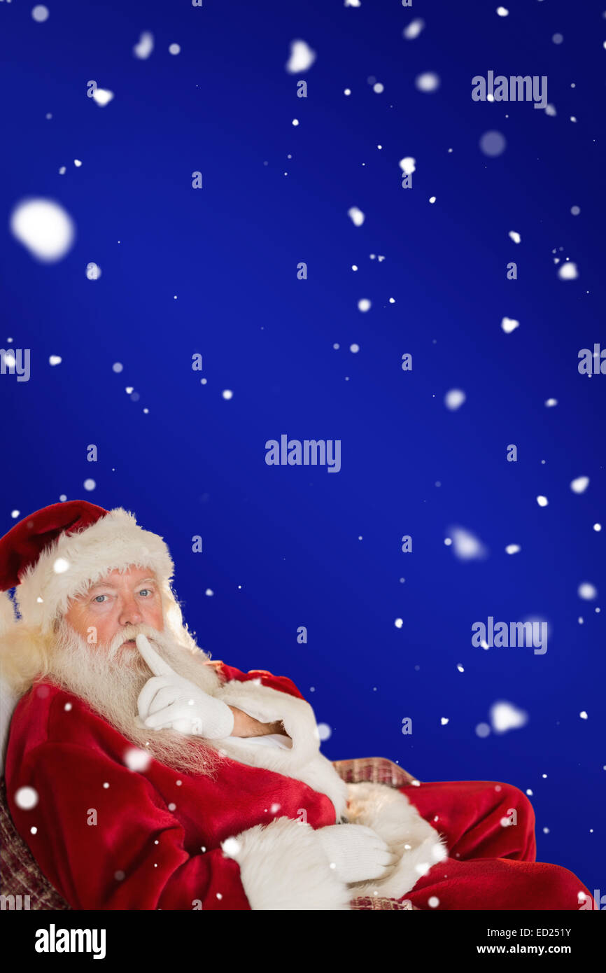 Composite image of santa asking for quiet Stock Photo - Alamy