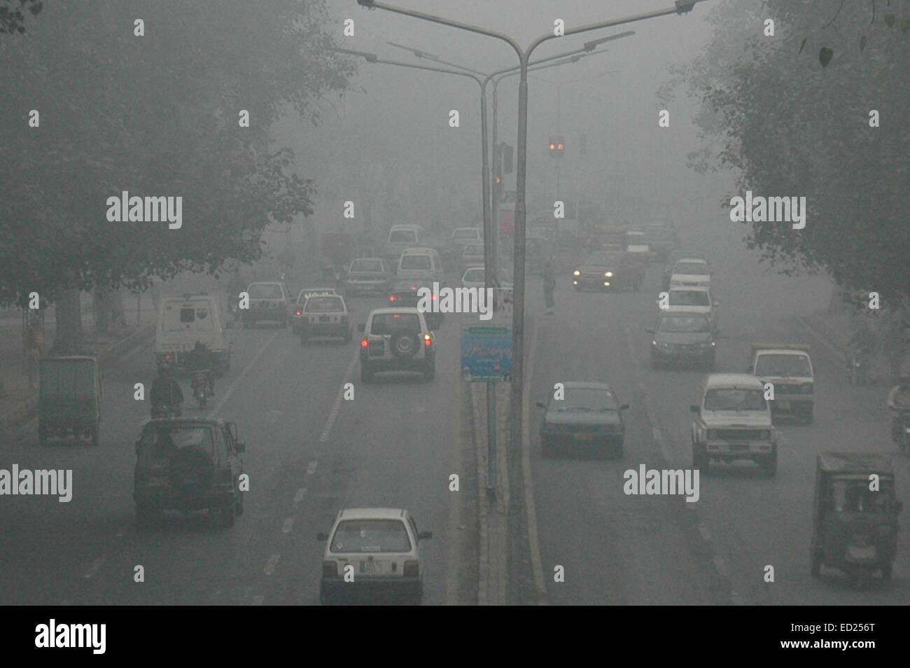 Lahore. 24th Dec, 2014. Vehicles travel on a road in heavy fog in ...