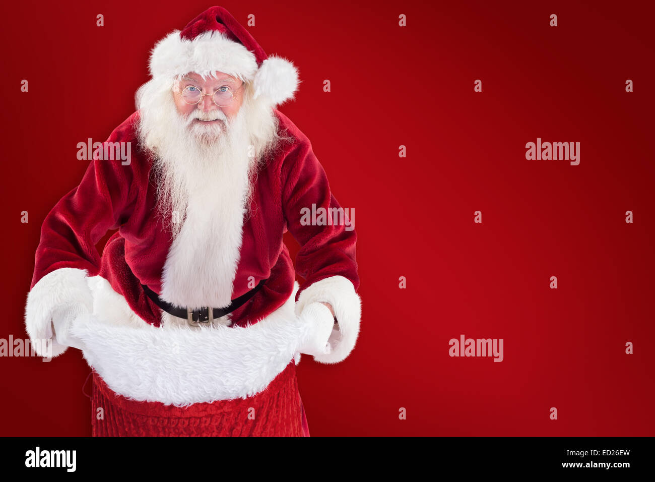 Composite image of santa open his red bag Stock Photo - Alamy
