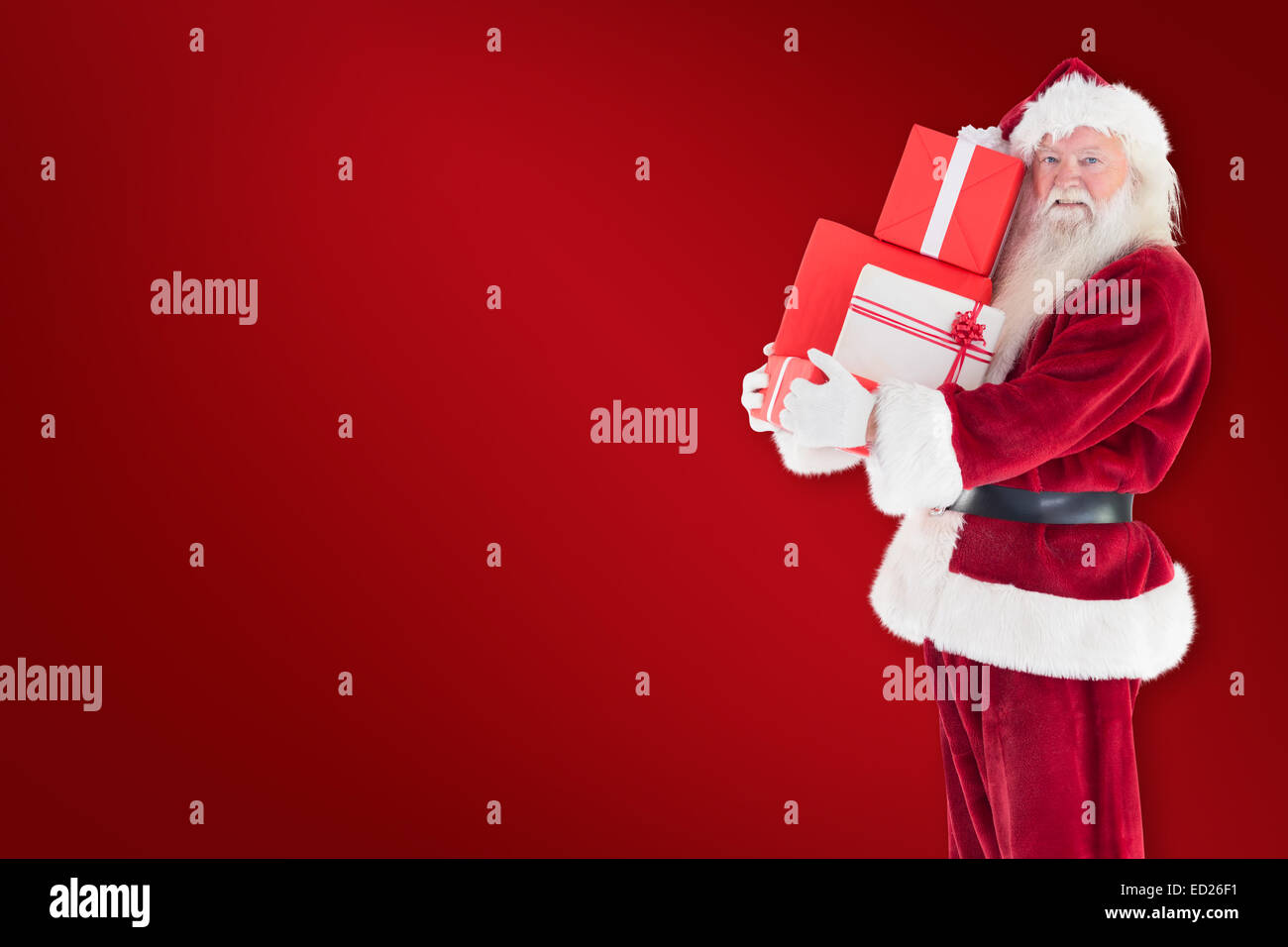 Composite image of santa carries a few presents Stock Photo - Alamy