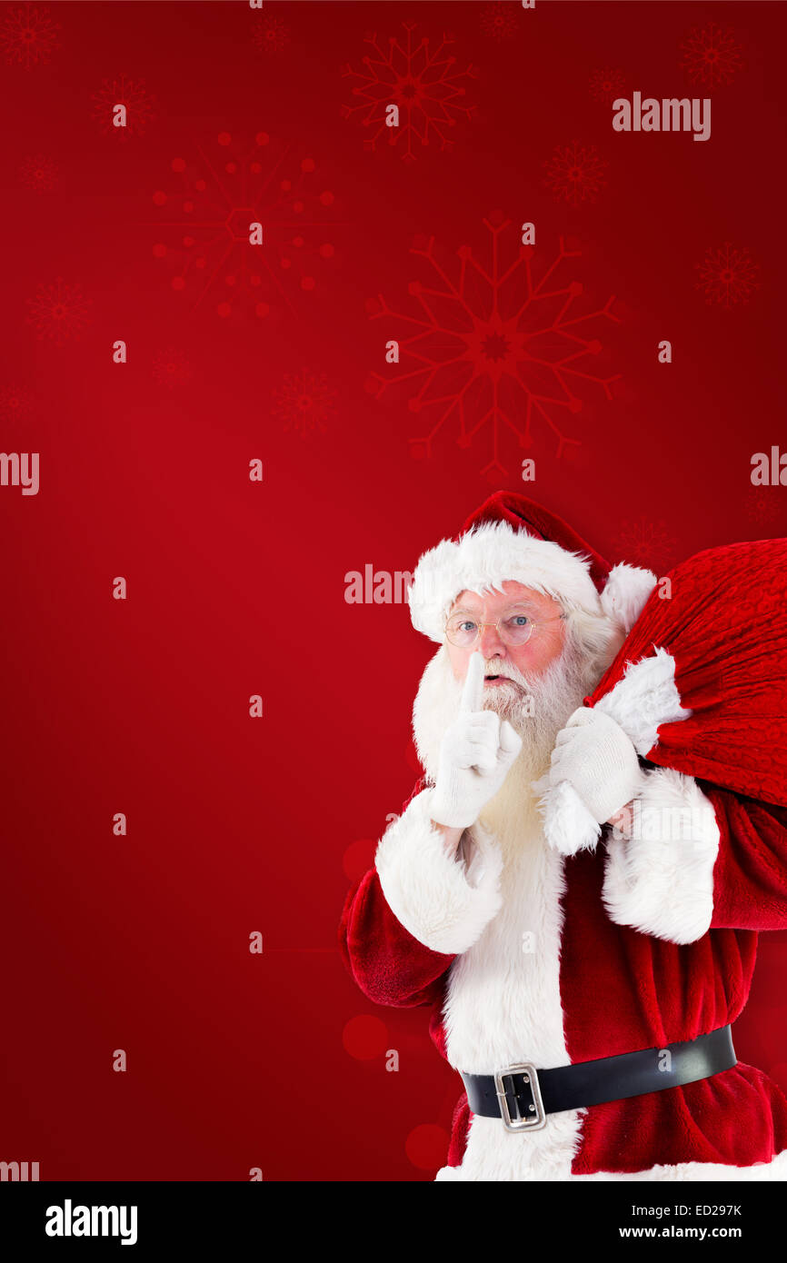 Composite image of santa claus carrying sack Stock Photo - Alamy